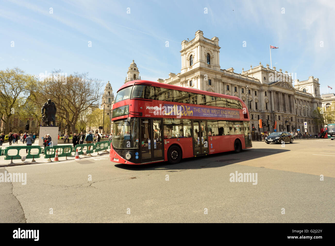Modern red bus traveling through Parliament Square in London on 1st of ...