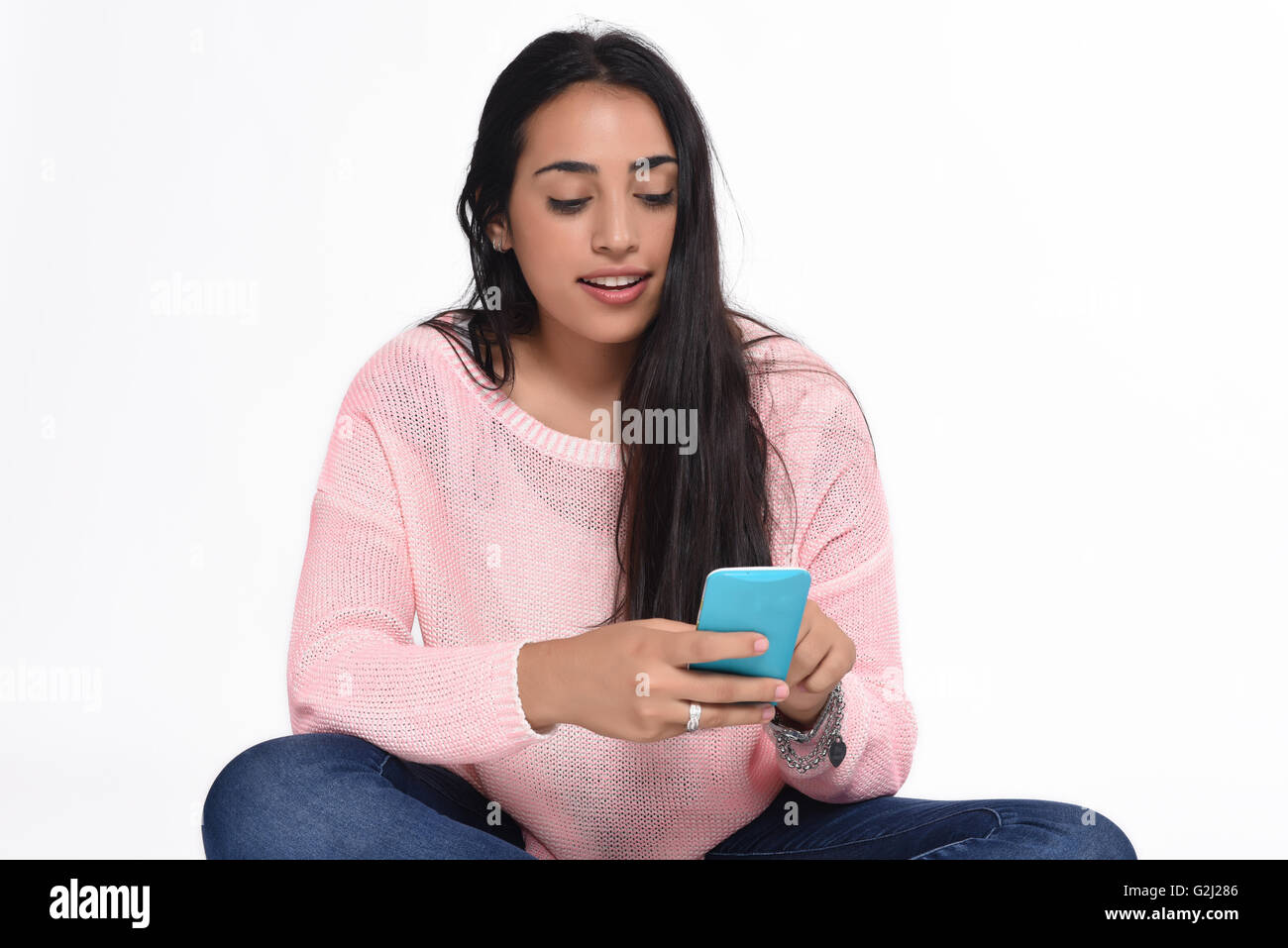 Young beautiful woman using her smartphone. Indoor. Isolated white ...