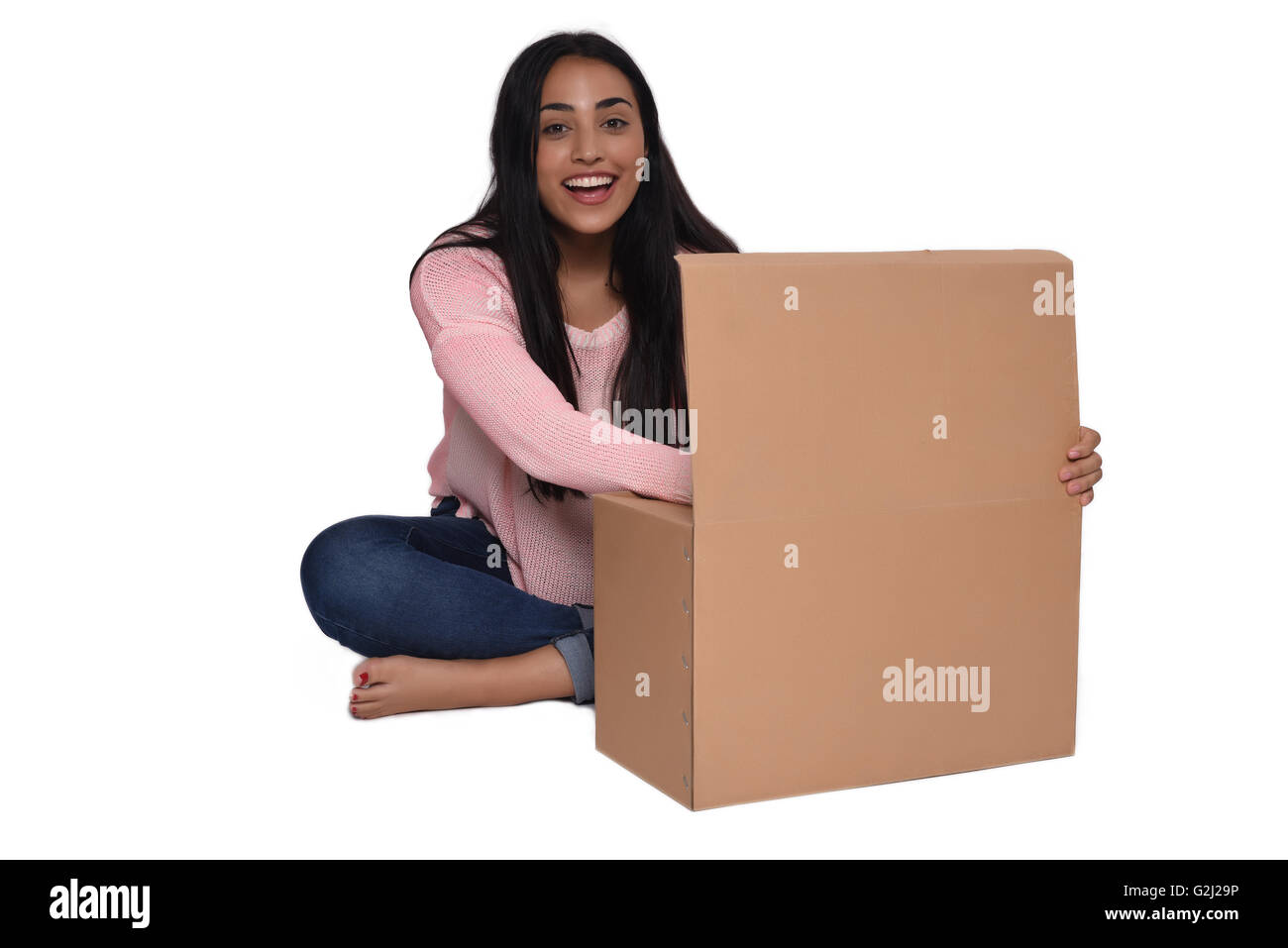 Young beautiful woman opening a box. Isolated white background Stock ...