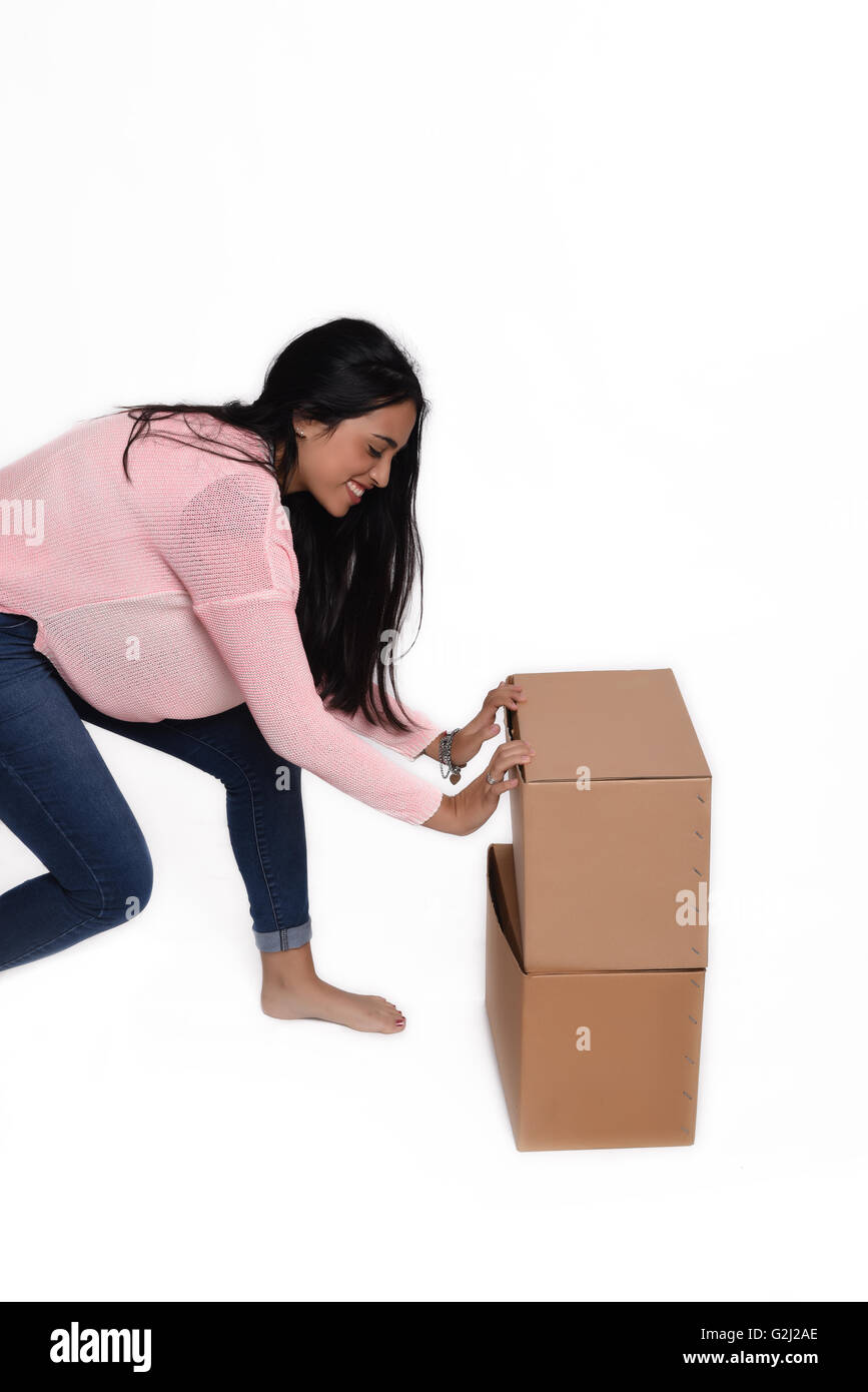 Young beautiful woman opening a box. Isolated white background Stock ...