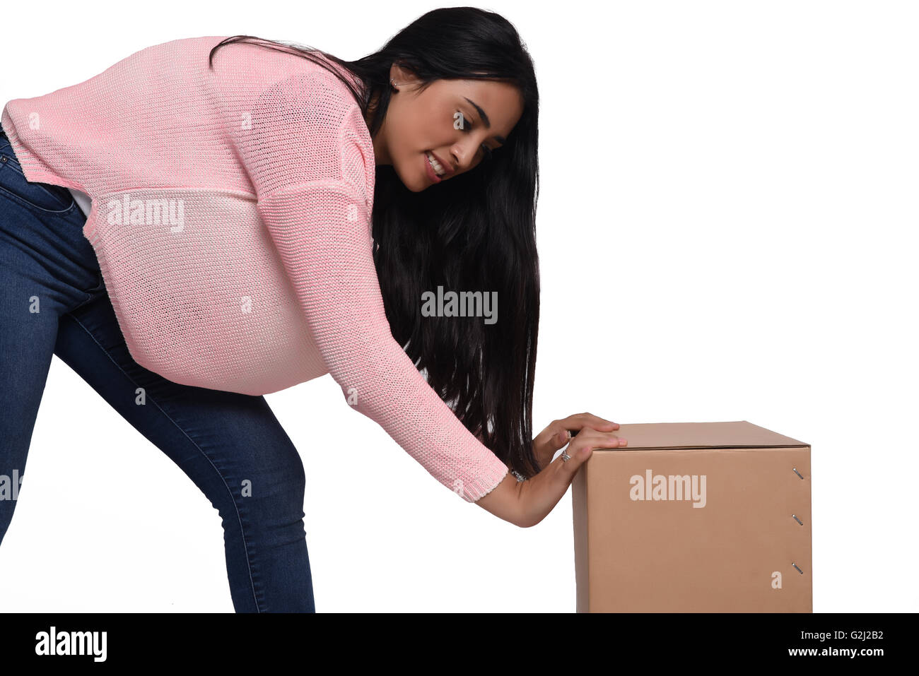Young beautiful woman opening a box. Isolated white background Stock ...