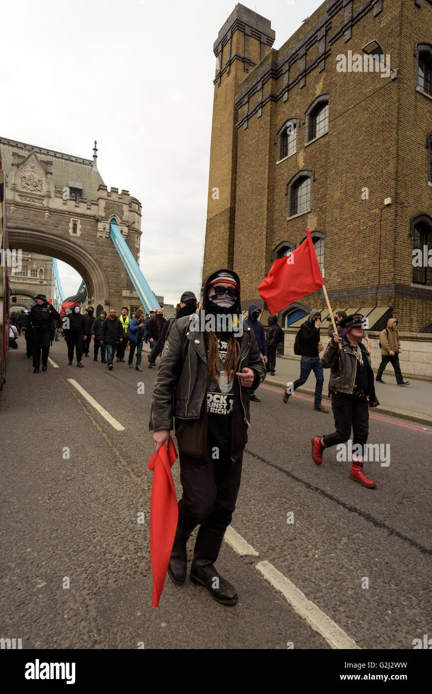 May Day Anarchist group with hidden faces, slogans and red flags ...