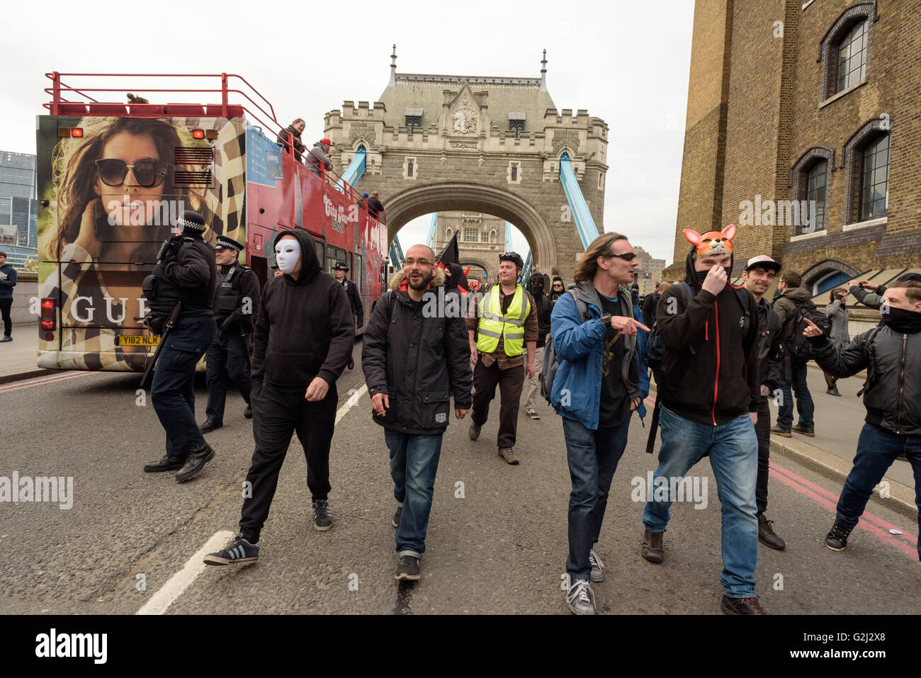 May Day Anarchist group with hidden faces, slogans and red flags ...