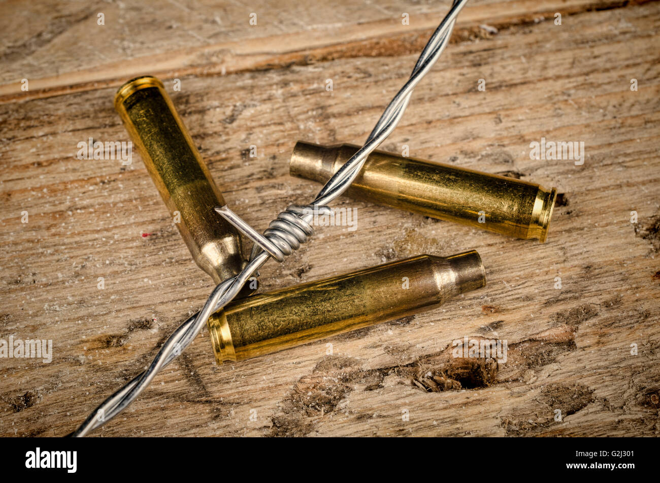 Bullet shells and barbed wire, a concept Stock Photo - Alamy