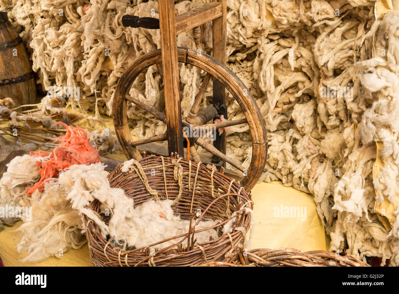 Old distaff surrounded by piles of raw wool Stock Photo - Alamy