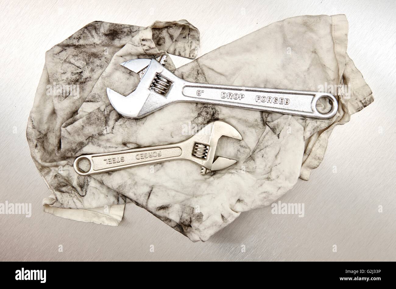 A studio photo of a wrench on an oily rag Stock Photo - Alamy