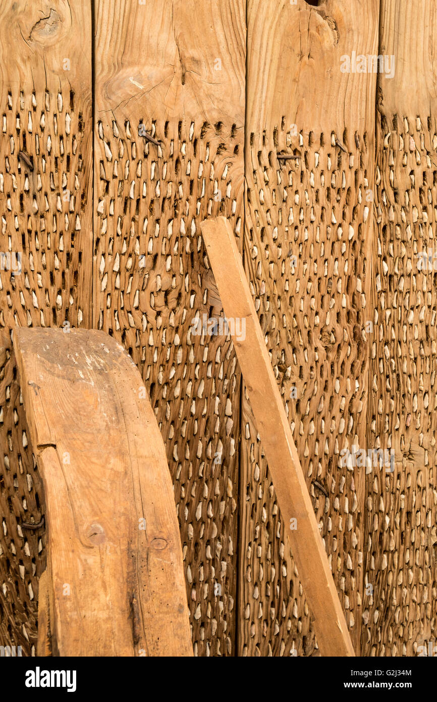 Vintage thresher made of wood and flint stone Stock Photo - Alamy