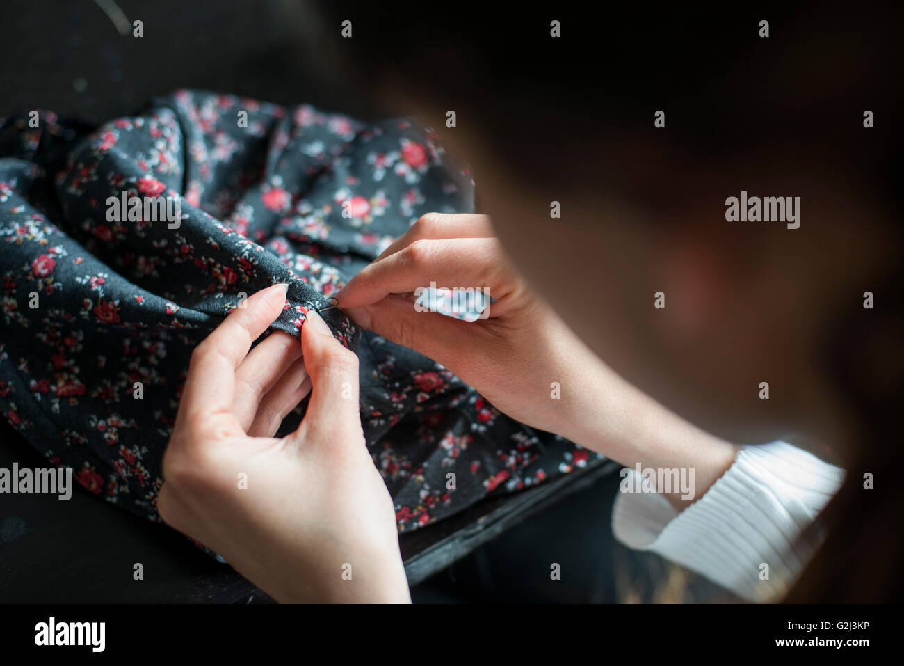 Young woman sewing clothes needle hi-res stock photography and images ...