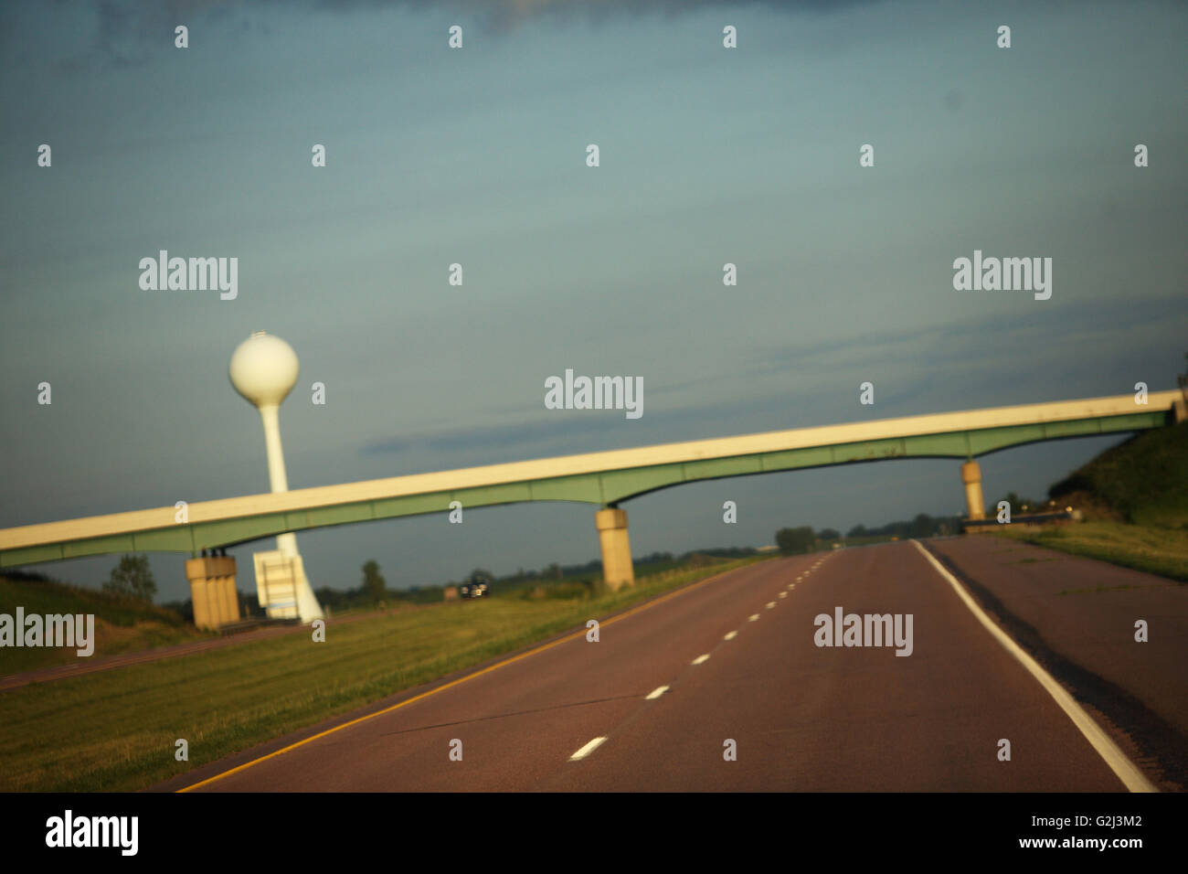 Two-Lane Highway With Bridge Overpass and Tower in Background ...