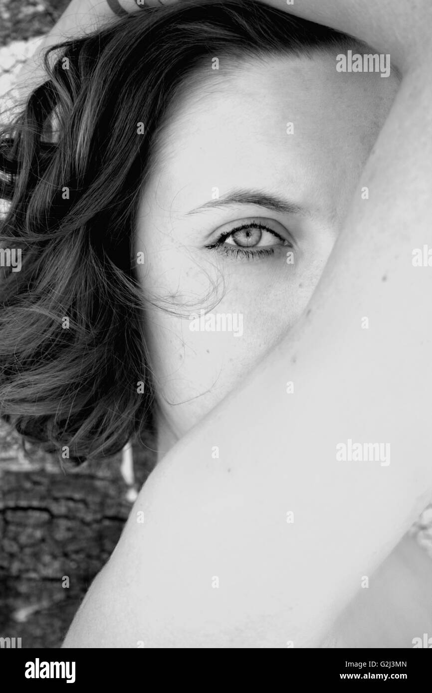 Young Woman Covering Face with Arm Stock Photo - Alamy
