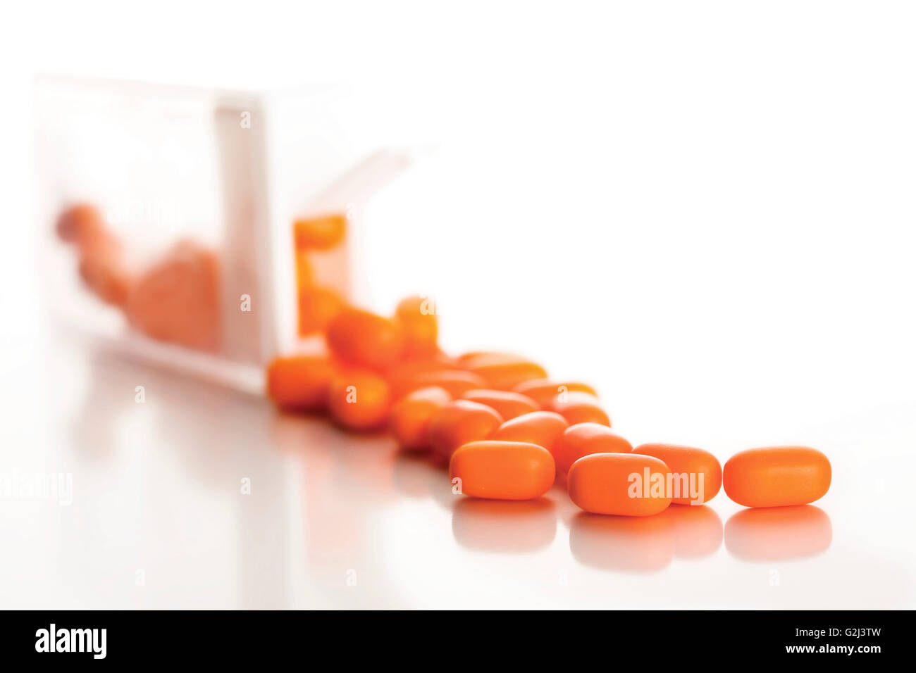 Orange Mints Spilling Out of Container Stock Photo - Alamy