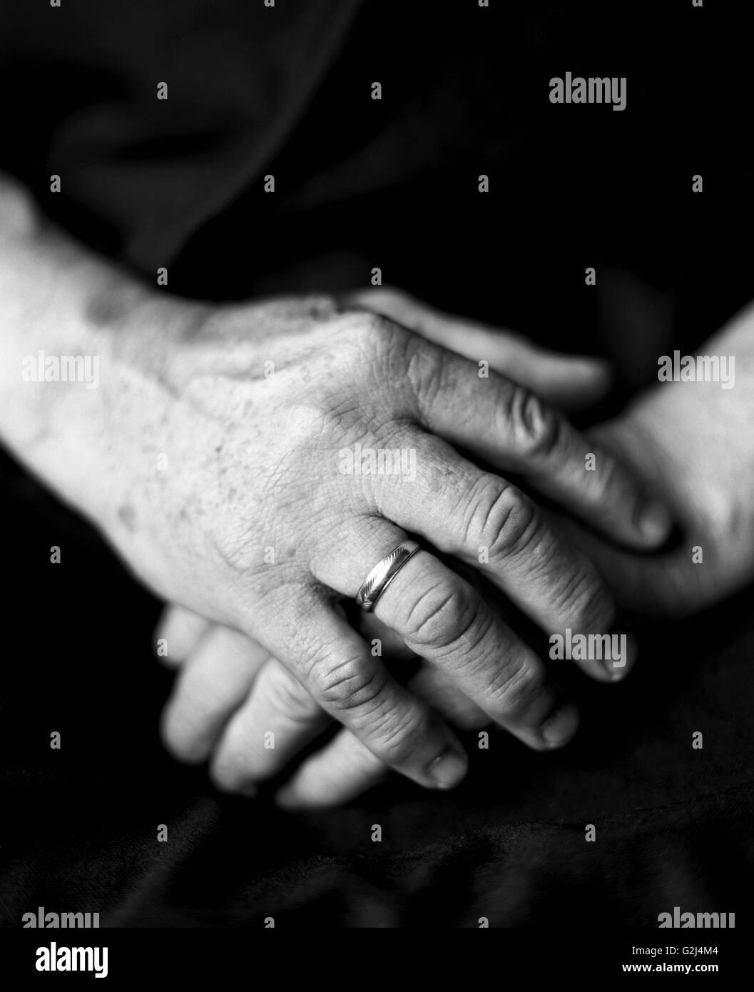 Elderly hands resting on lap Black and White Stock Photos & Images - Alamy