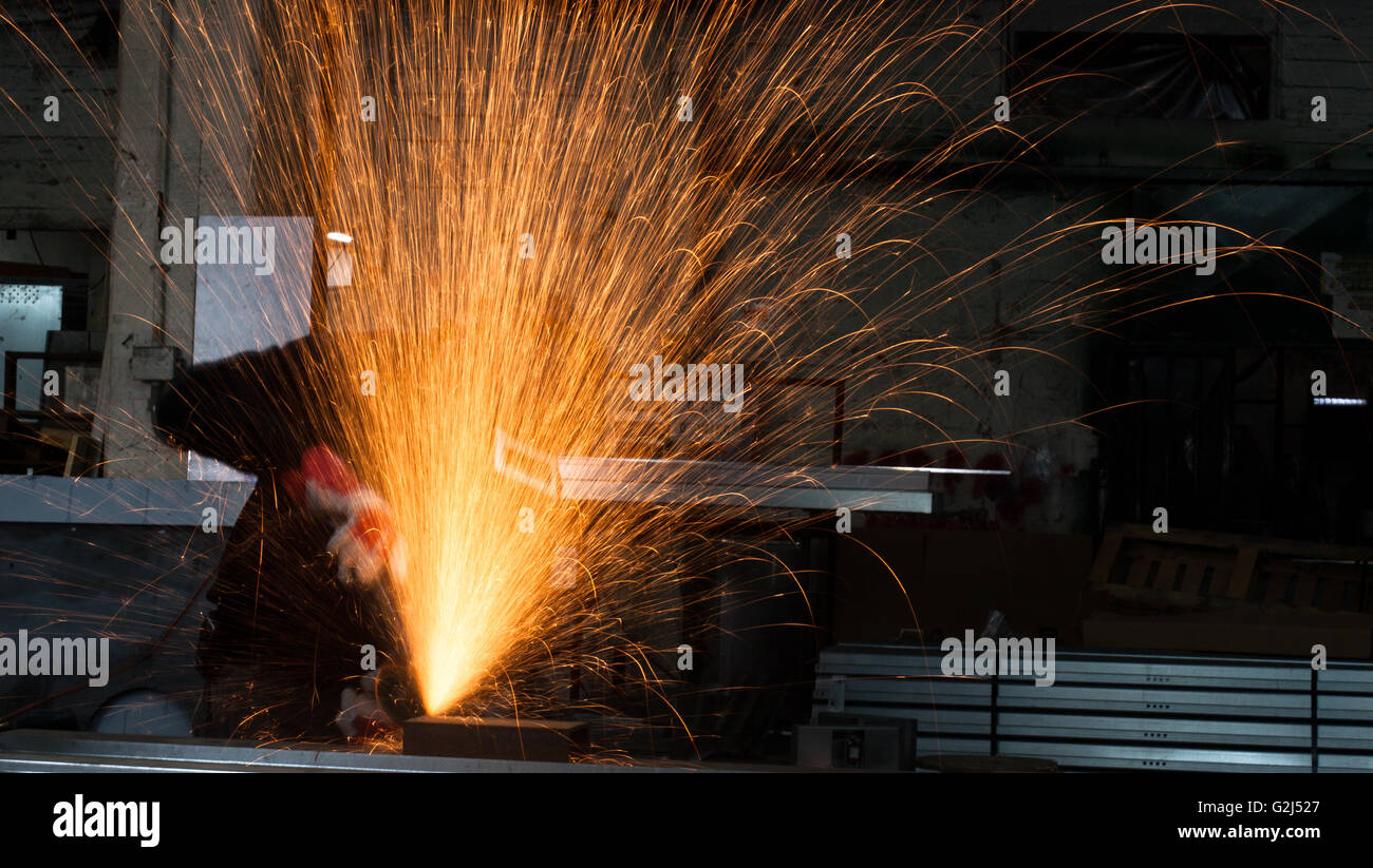 sparks explosion during grinding in a metal workshop Stock Photo - Alamy