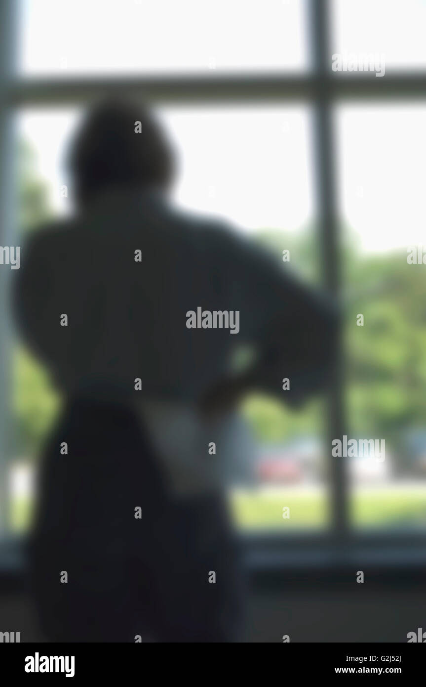 Blurred Woman Looking out Window, Rear View Stock Photo - Alamy