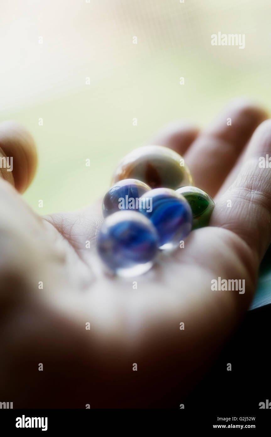 Marbles in Hand Stock Photo - Alamy