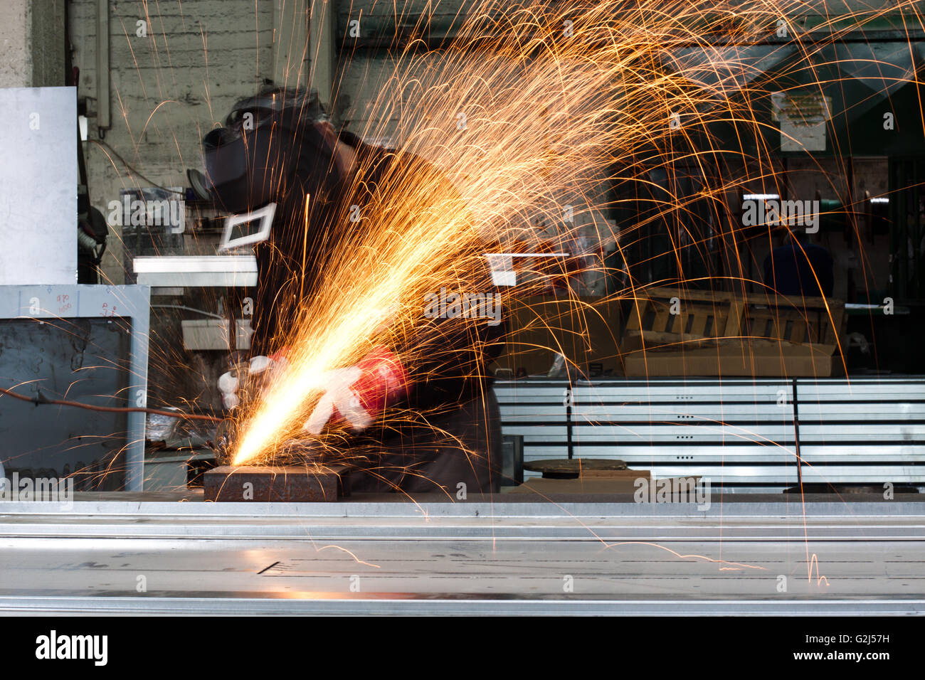 sparks flying during grinding in a metal workshop Stock Photo - Alamy