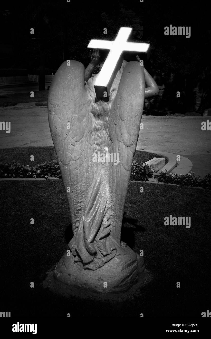 Angel holding cross Black and White Stock Photos & Images - Alamy