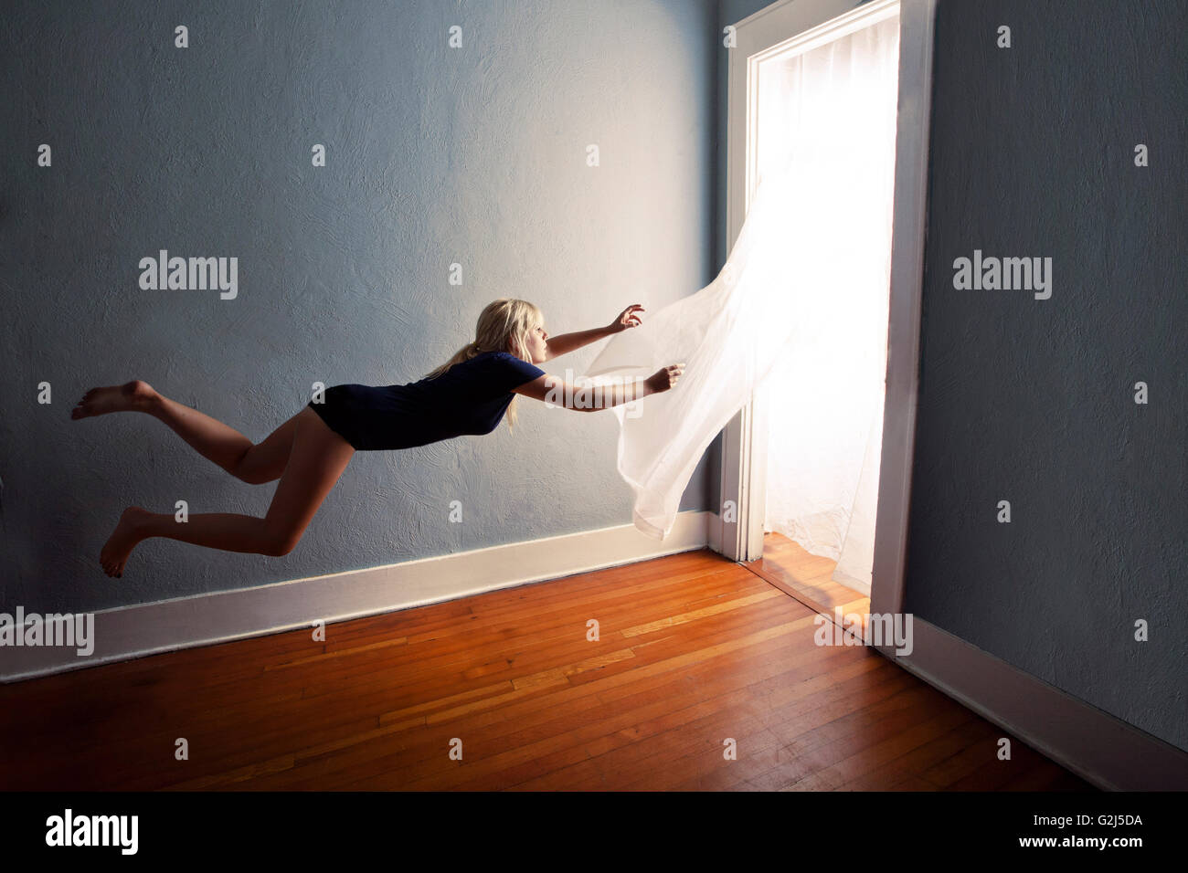 Levitating Woman Holding Curtains Stock Photo - Alamy