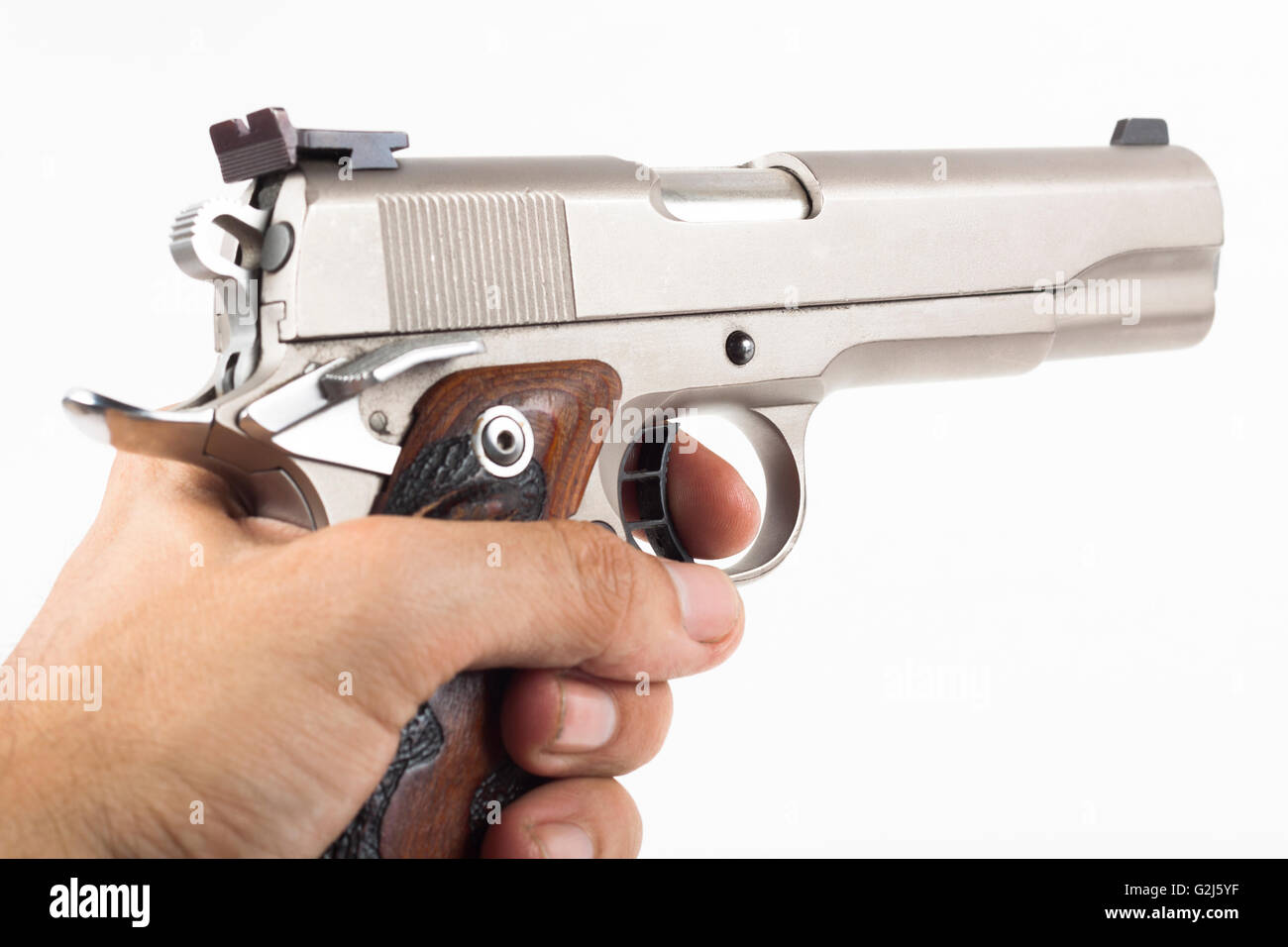Hand holding silver colored gun isolated on white background Stock ...