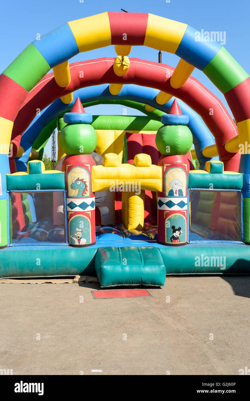 Brightly colored deserted bouncy castle with nobody enjoying the ...
