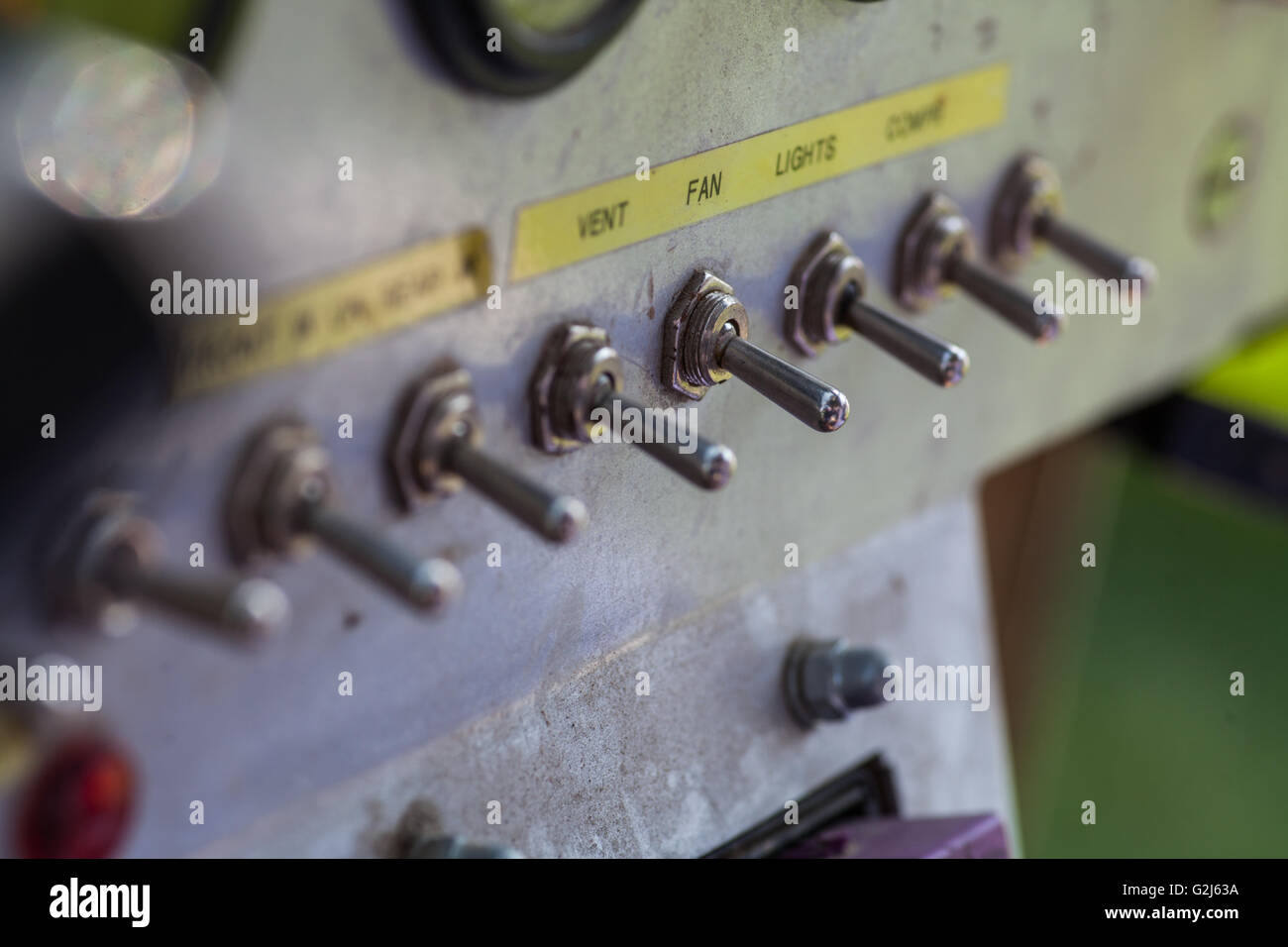 Close up shot with a line a switches on a control panel Stock Photo - Alamy
