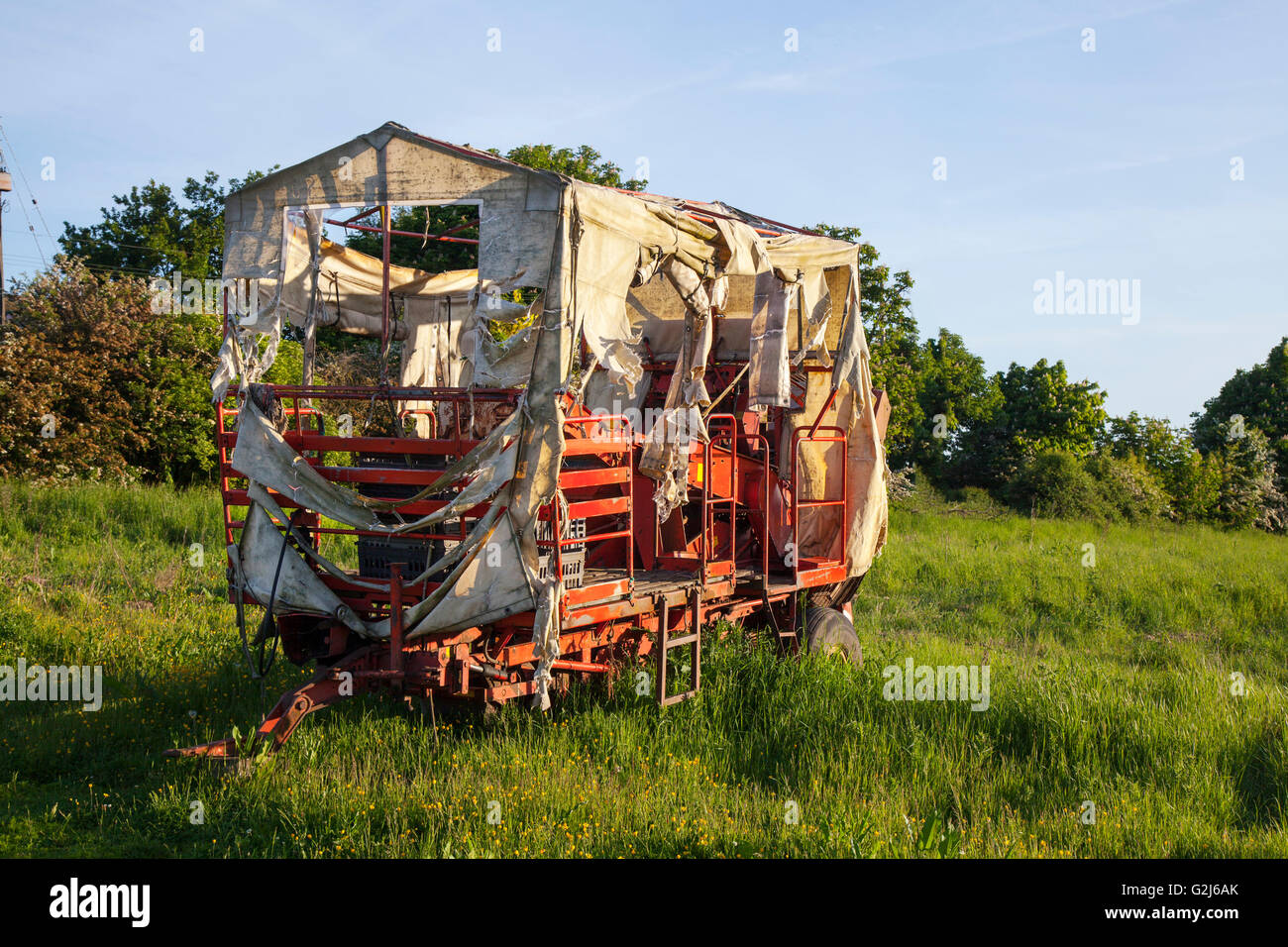 Disused GRIMME farm potato harvesting trailer illuminated in low light ...