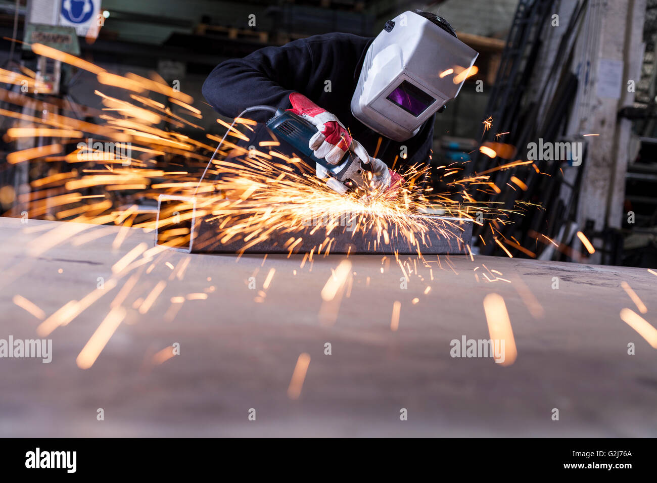 Metal industry worker grinding with mask on the face Stock Photo - Alamy
