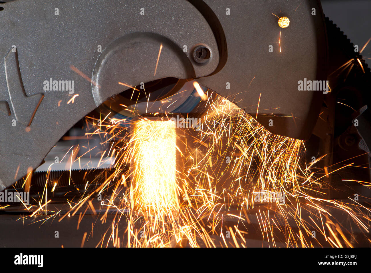 metal cutting saw throwing sparks all over Stock Photo - Alamy