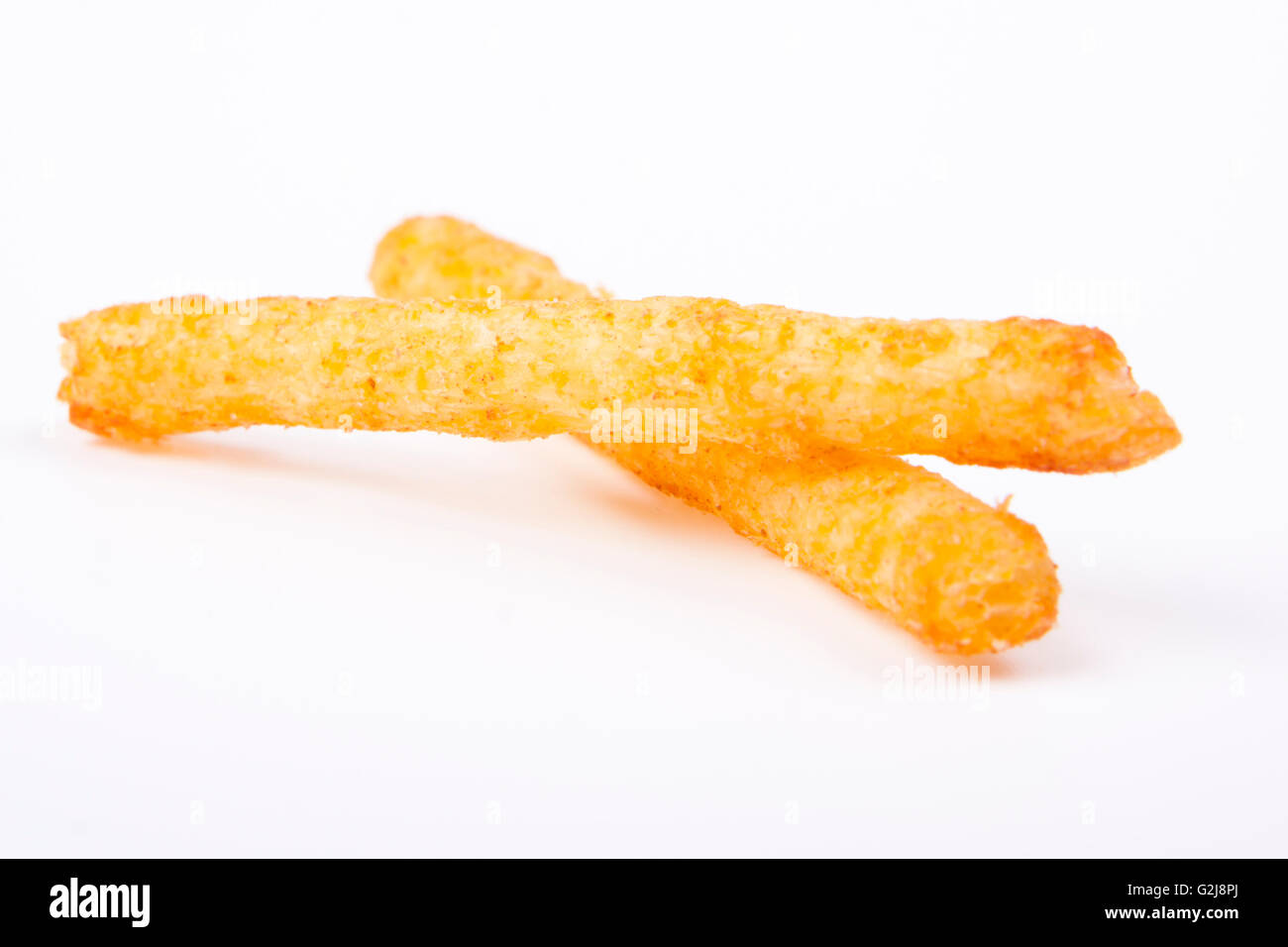 two spiced french fries on white background Stock Photo - Alamy