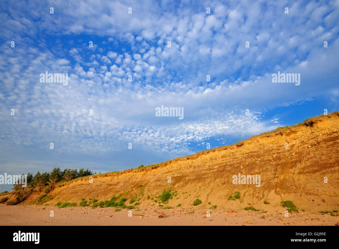 Red cliffs and clouds along Aspy Bay Cabot Landing Provincial Park Nova ...