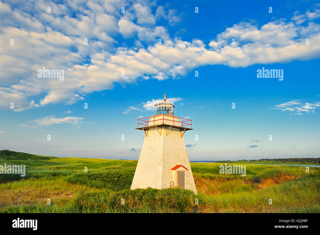 Lighthouse in sand dunes with clouds Stock Photo - Alamy