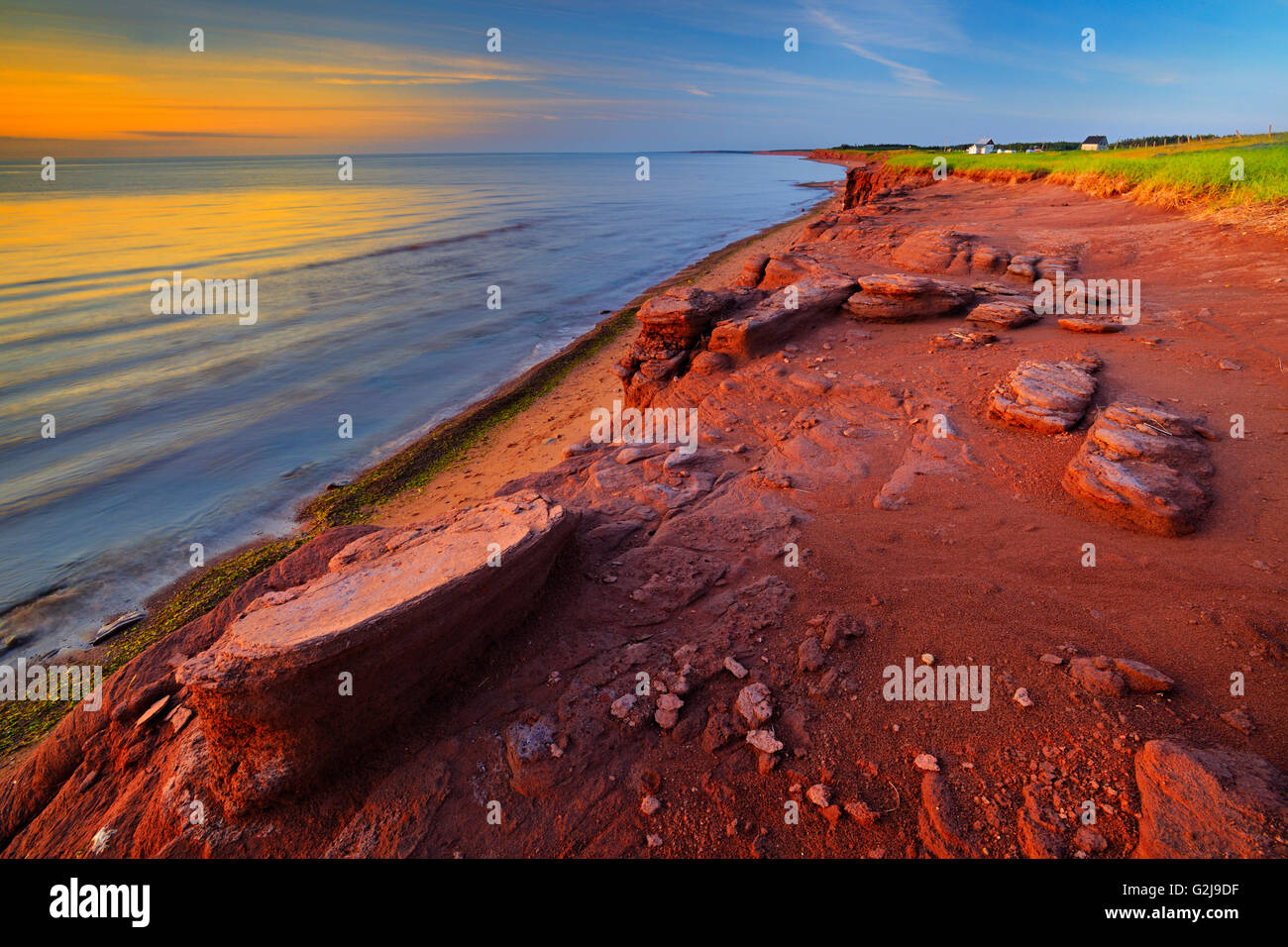 Red cliffs along Gulf of St. Lawrence at sunset Stock Photo - Alamy