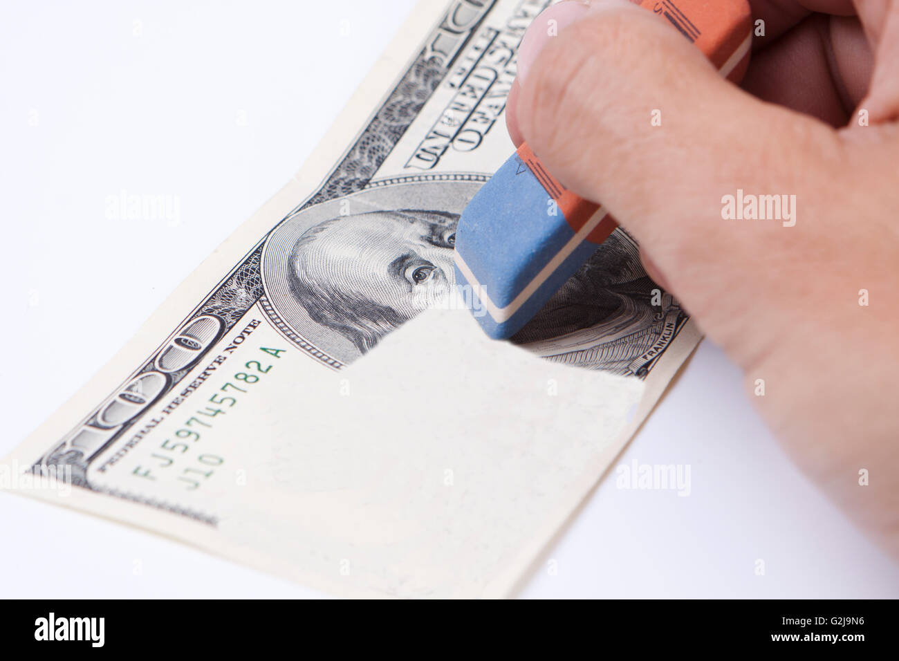 erasing 100 dollar bill with a blue eraser Stock Photo - Alamy