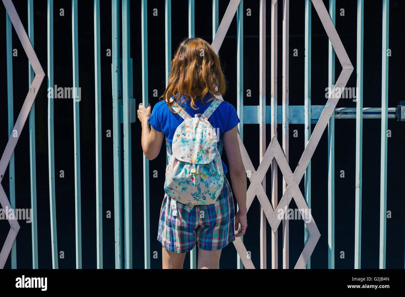 Woman peeking through door hi-res stock photography and images - Alamy