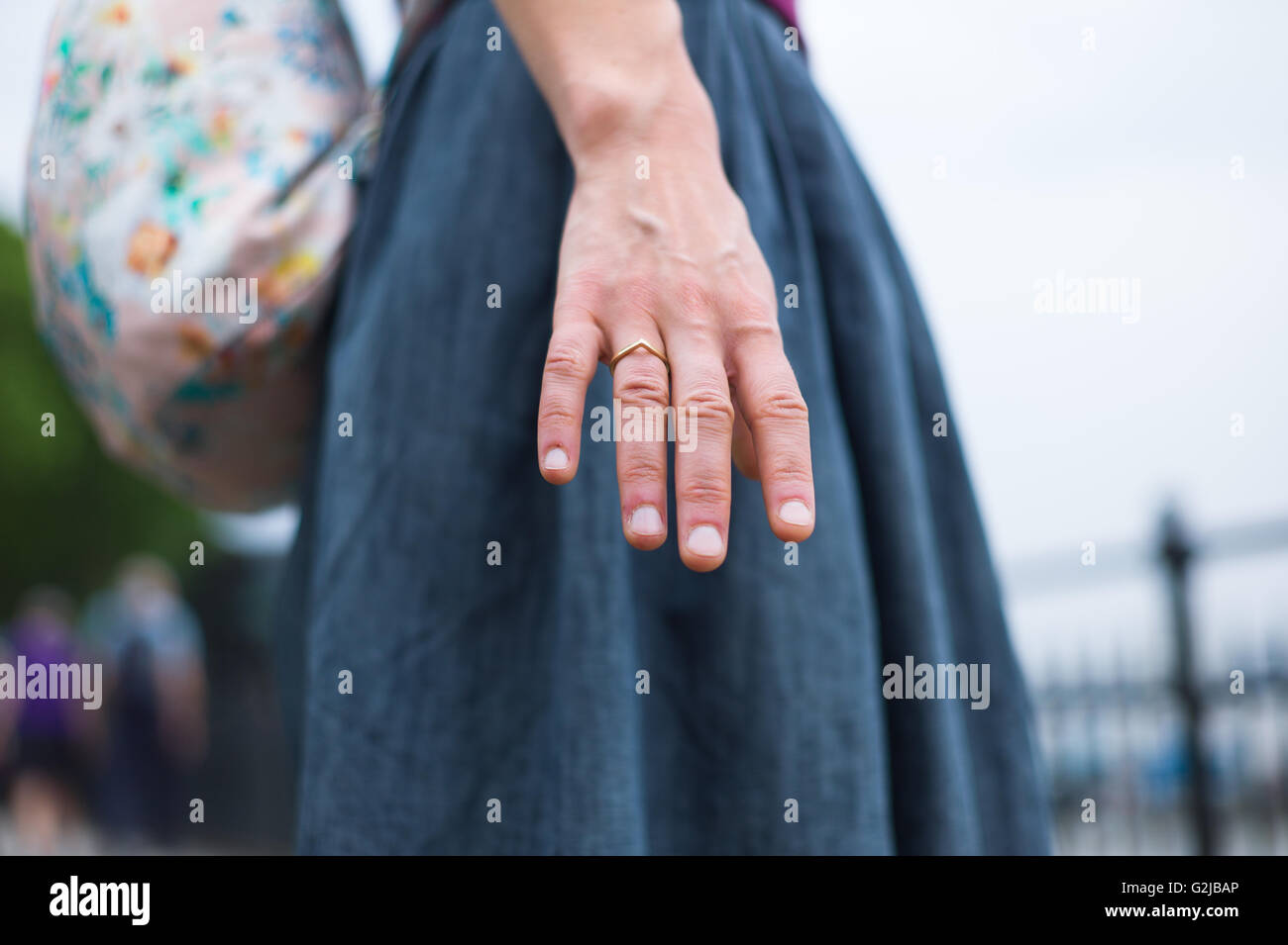 A young woman is extending her hand outside Stock Photo - Alamy
