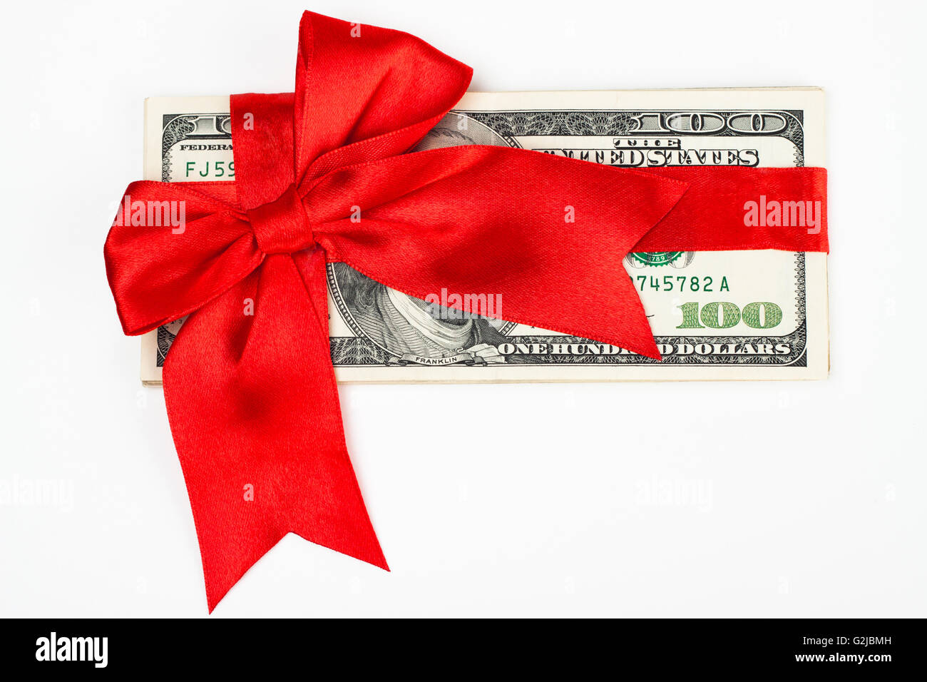 dollars wrapet up with a red ribbon isolated on white background Stock ...