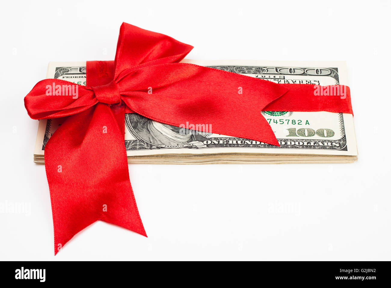 dollars wrapet up with a red ribbon isolated on white background Stock ...