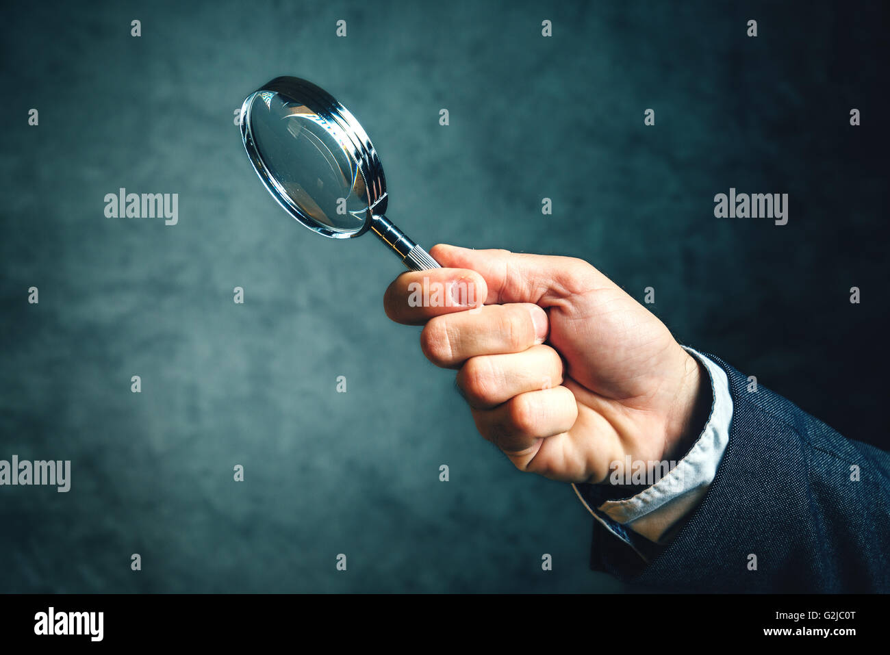 Hand holding magnifying glass reading hi-res stock photography and ...