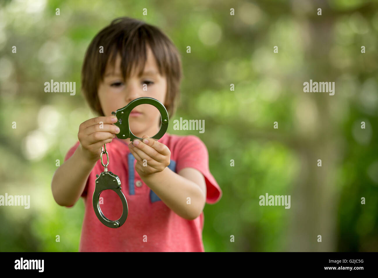 Handcuffs kid hi-res stock photography and images - Alamy
