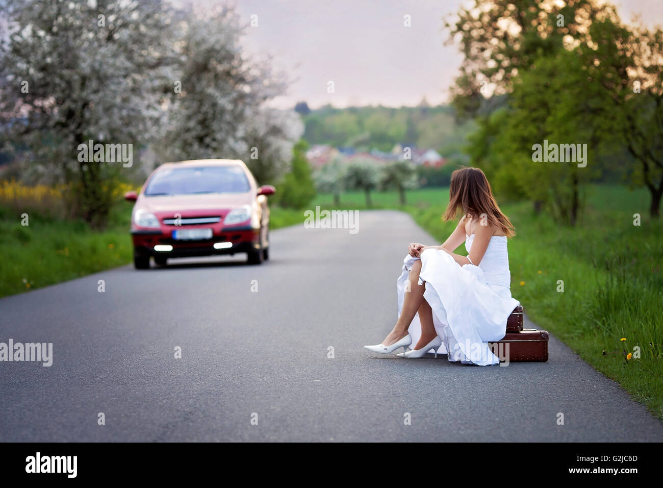 Young bride on the road with a suitcase Stock Photo - Alamy