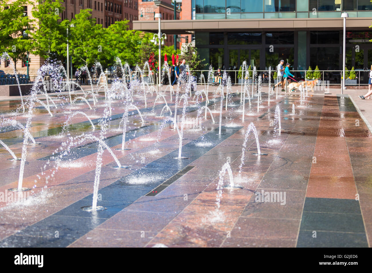 Urban plaza with jet fountains at front of Union Station in Denver ...