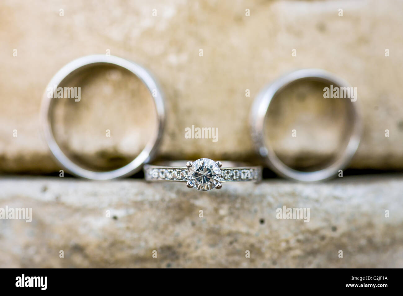Engagement Ring with Wedding Rings in the background Stock Photo - Alamy