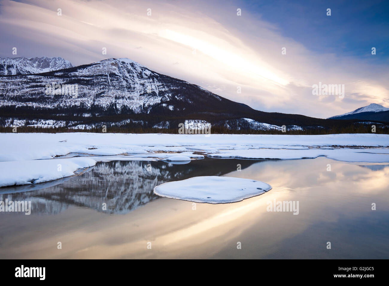 Scenic snow capped mountain reflected in the Athabasca River, Jasper ...