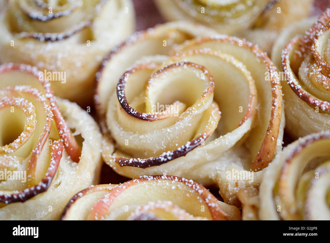 Sweet puff pastry roses with powdered sugar Stock Photo - Alamy