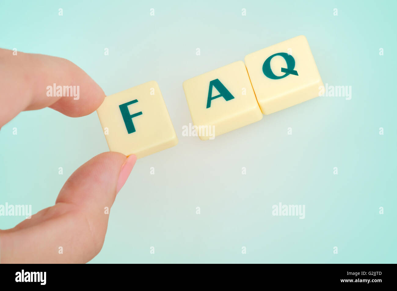 FAQ word on blue background Stock Photo - Alamy