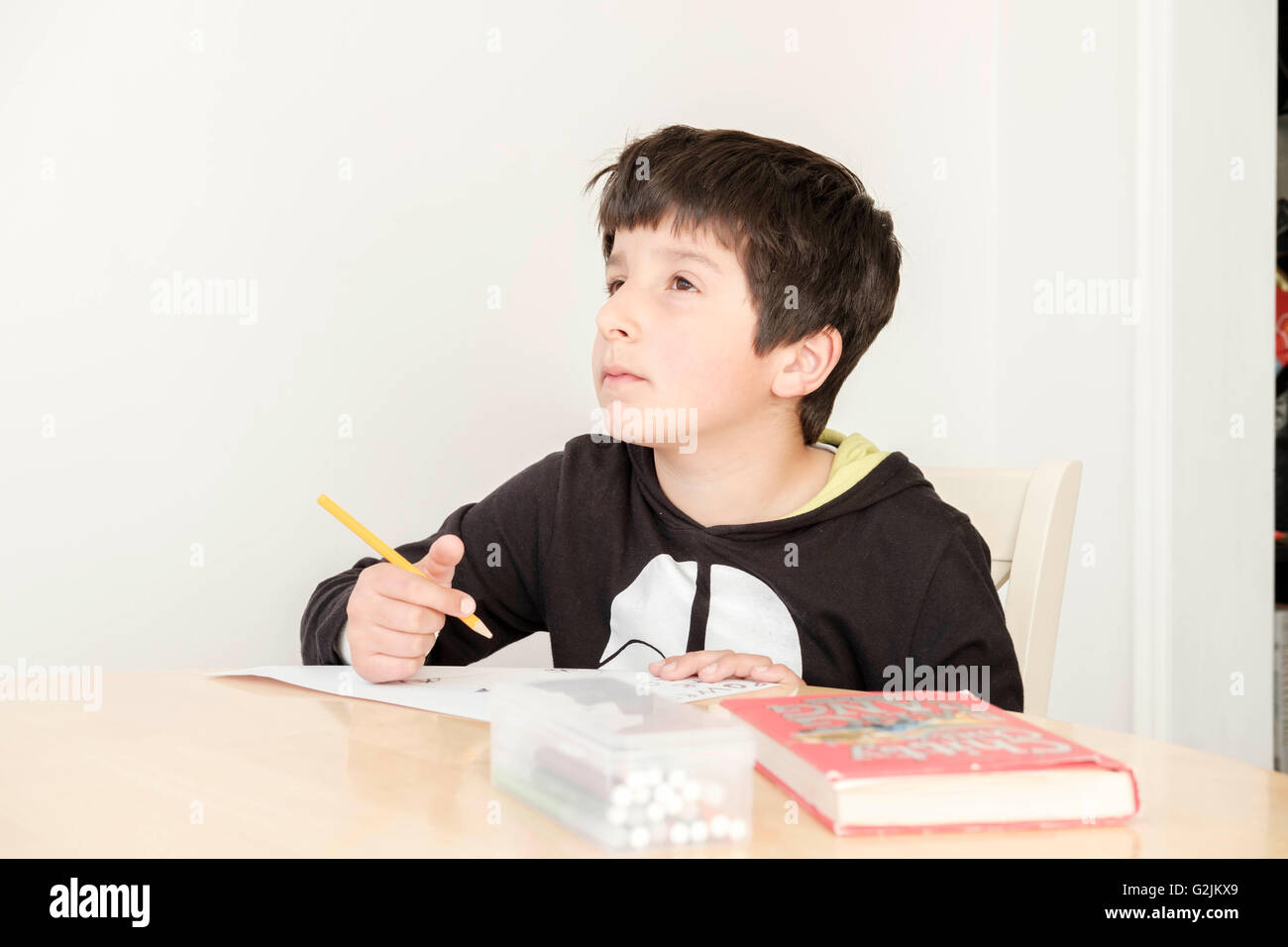 Schoolboy working on his homework Stock Photo - Alamy