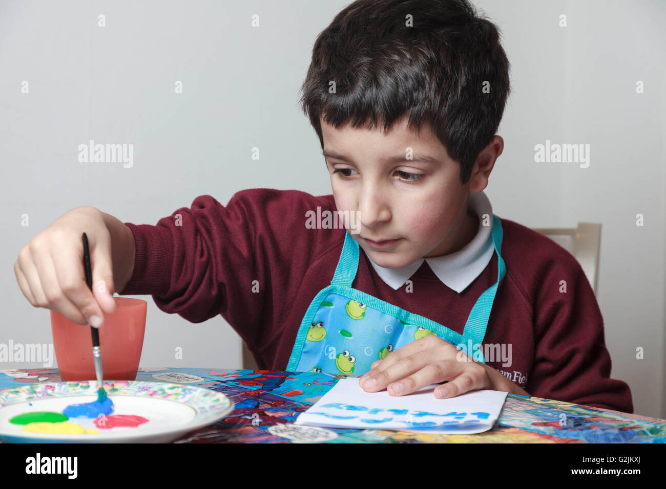Art class in primary school-schoolboy paint a picture Stock Photo - Alamy