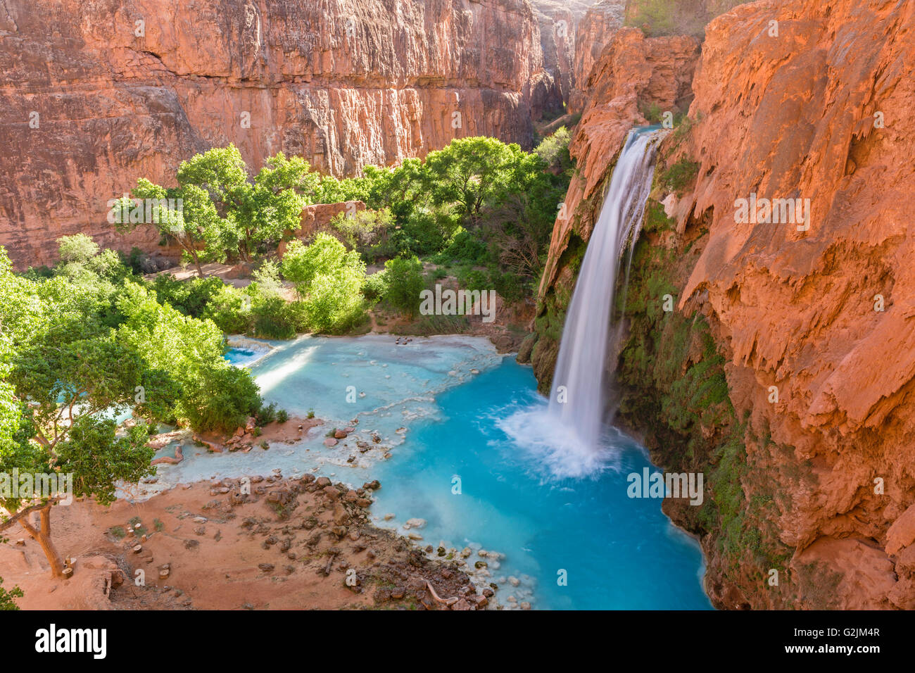 Havasu Falls plunges into a deep blue-green pool, with Cataract Canyon ...