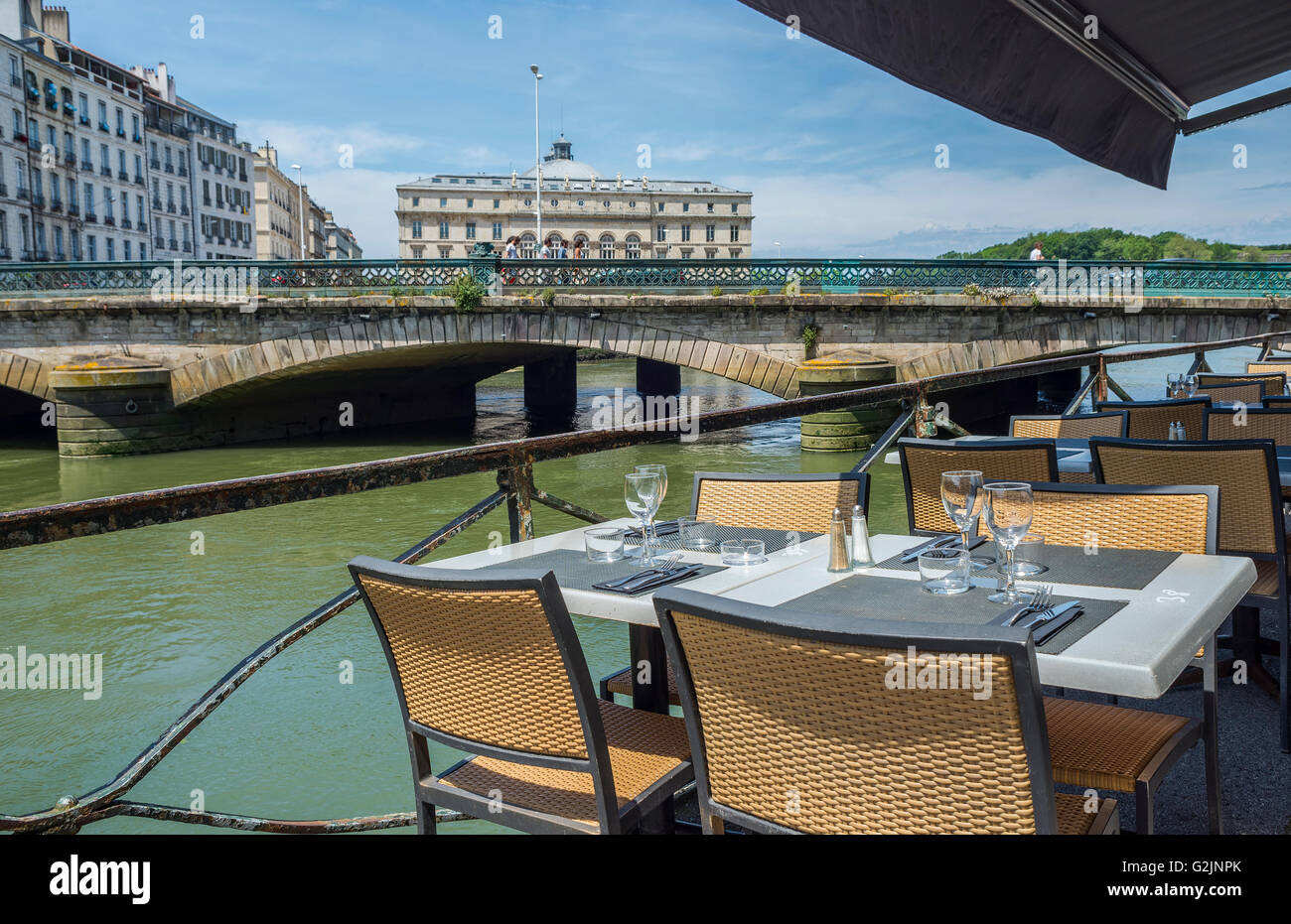 Bistro terrace next to Pont Mayou bridge over Le Nive river with Hotel ...