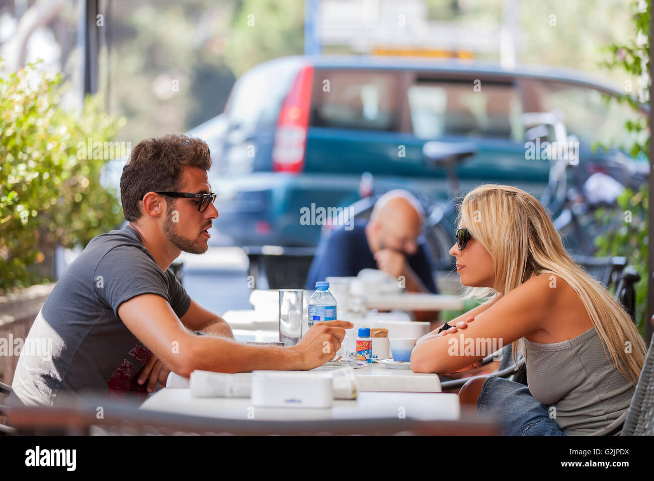 Young people at a cafe in the seaside town Stock Photo - Alamy